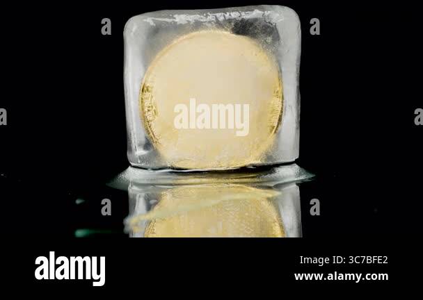 Gold Ethereum Coin Partially Encased in a Melting Ice Cube on a ...