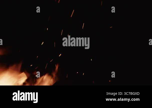A dynamic close-up of a roaring fire showcases vibrant flames dancing ...