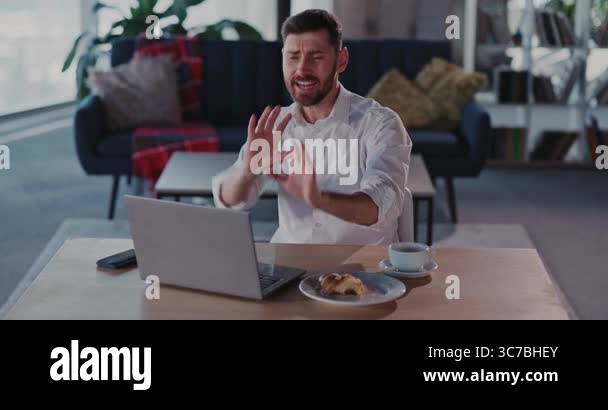 A dedicated man communicates efficiently while working from home ...