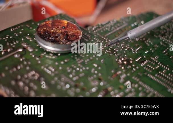 Close-up macro view of a hot soldering iron tip cleaned in rosin flux ...