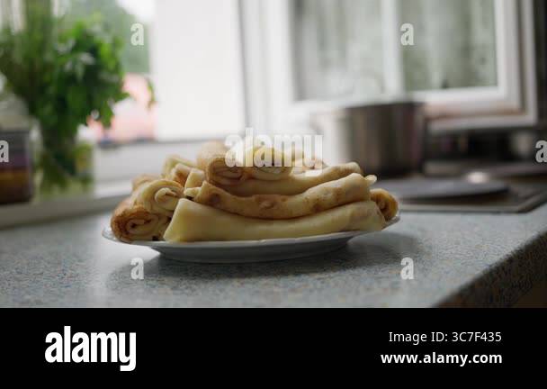 A tempting and delicious stack of freshly made crepes artfully arranged ...
