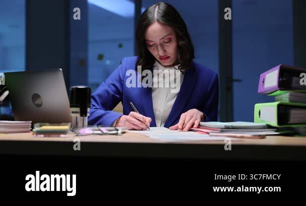 Secretary writes information in official document late in evening ...