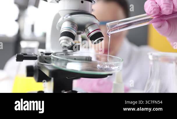 Laboratory technician pours clear gel on surface of sterile Petri dish ...