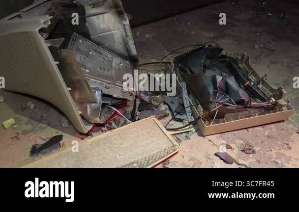 Destroyed vintage computer monitor with shattered screen and tangled ...