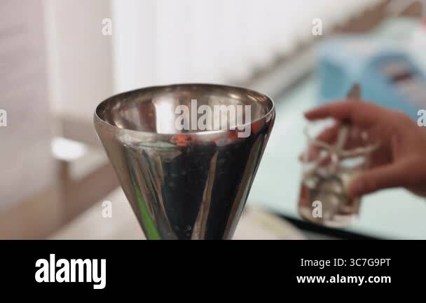 Liquid pouring, glass beaker, metal container. Pouring clear liquid ...