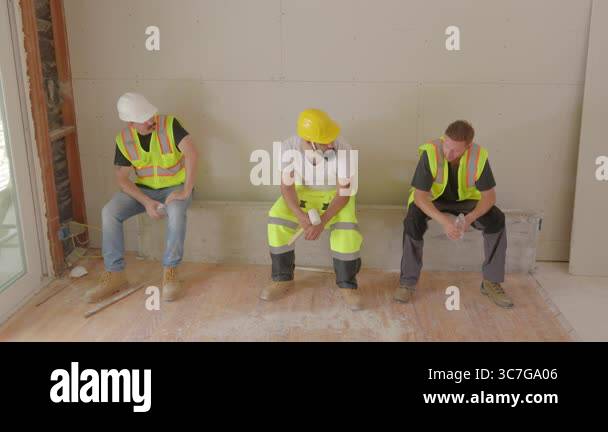 Diverse group of skilled builders gathered during the brake at busy ...