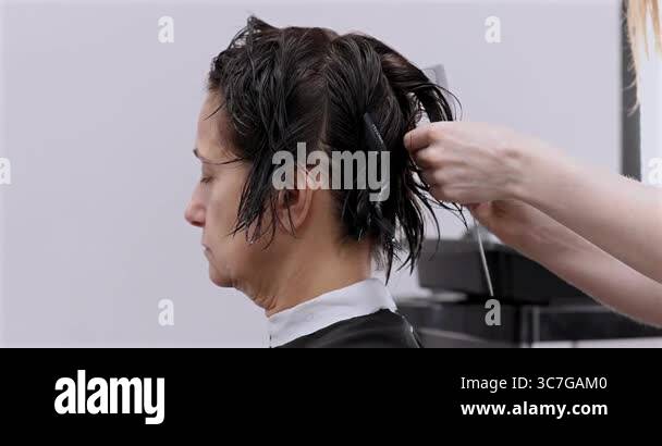 Professional hairdresser working with client, closeup. Hairdresser ...