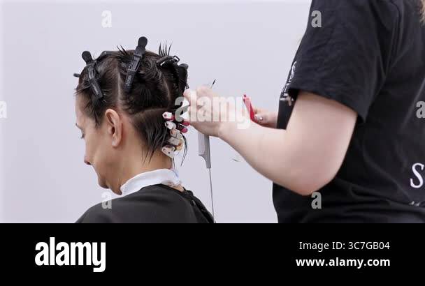 Professional hairdresser working with client, closeup. Hairdresser ...