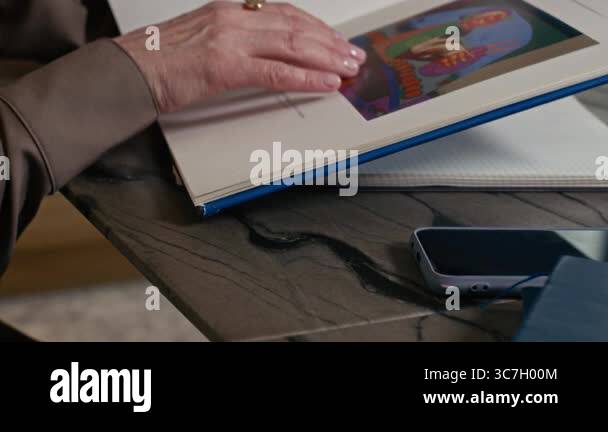 Tilt up closeup shot of mature Caucasian woman working in modern art ...