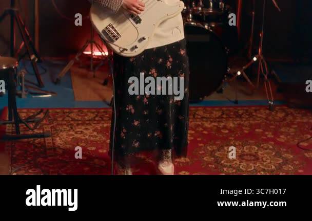 Tilt-up shot of young girl in white shirt intently playing white ...