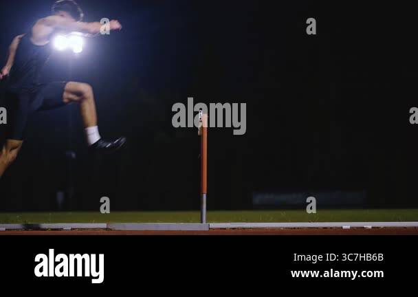 Strong Male Athlete is Running Towards an Obstacle, Hurdling, Jumping ...