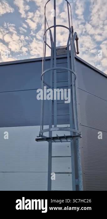 fire ladder leading to the roof of the hall. cylindrical water tank ...