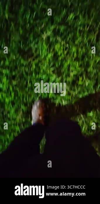 A first-person perspective video capturing the view of legs clad in ...