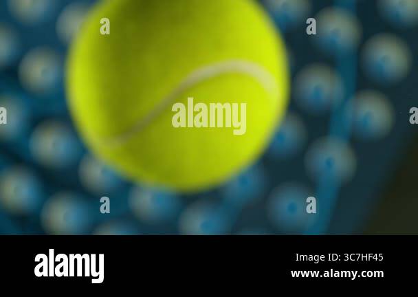 Padel racket and ball hit against black background . Filmed on High ...