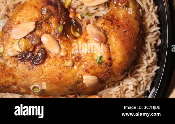 A delicious chicken leg sits on fragrant rice with nuts Stock Video ...