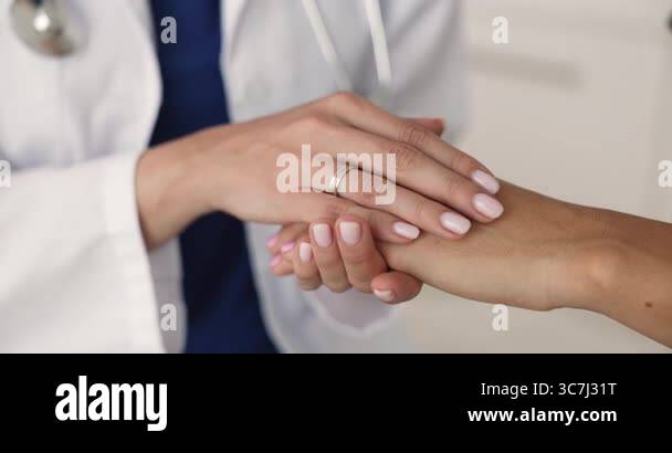 Close up of compassionate gesture between doctor and patient, female ...
