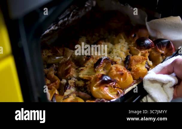 Cook sprinkles paprika on duck or goose stuffed with apples and lemon ...