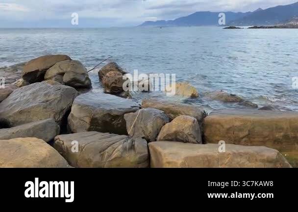 Sea part with distant mountain shore in overcast day Stock Video ...