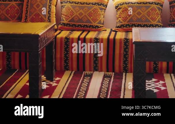 Traditional Moroccan interior design with colorful cushions, striped ...