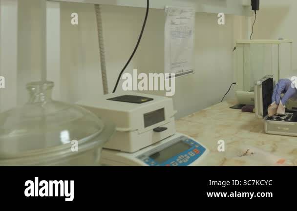 People work in a chemical laboratory. Protective clothing, equipment, bright lights. Slow Motion ...