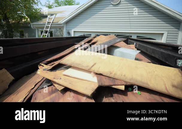 Dumpster with garbage from the old roof. Roofer dismantles old roof ...