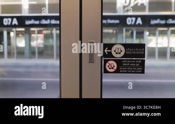Passenger Pressing Bus Door Button. A close-up image shows a passenger ...