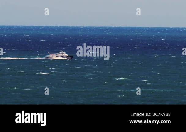 Nice, France - March 17, 2025: Distant view of a boat moving on the ...