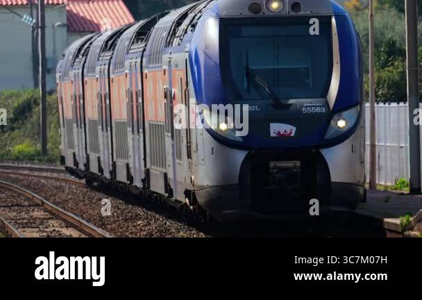Nice, France - March 11, 2025: A blue train arriving at the station in ...