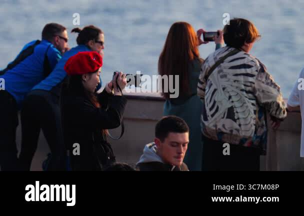 Nice, France - March 10, 2025: Woman wearing a red beret taking ...