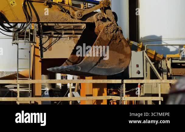 Close up of a yellow crane machine moving and lifting on a construction ...