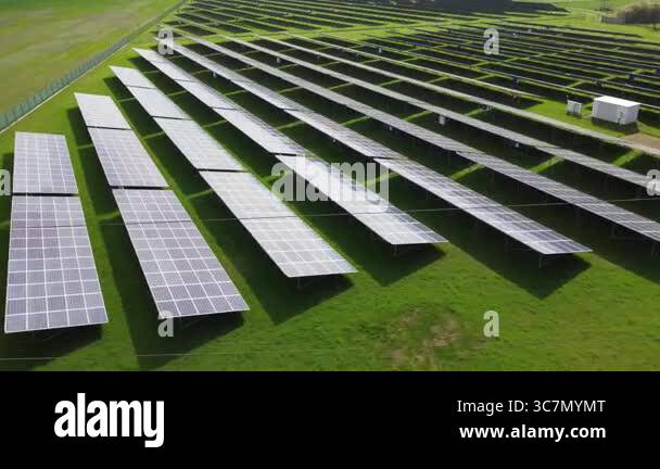 Aerial view, large solar farm showcasing rows of photovoltaic panels ...