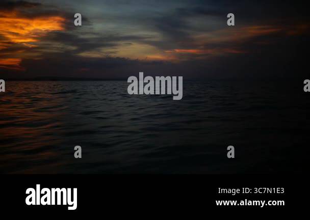 the view of the sunset on the pacific ocean, the sea water is so calm ...