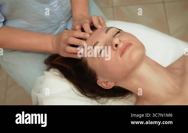 Touching forehead gently to promote deep relaxation and energy flow ...