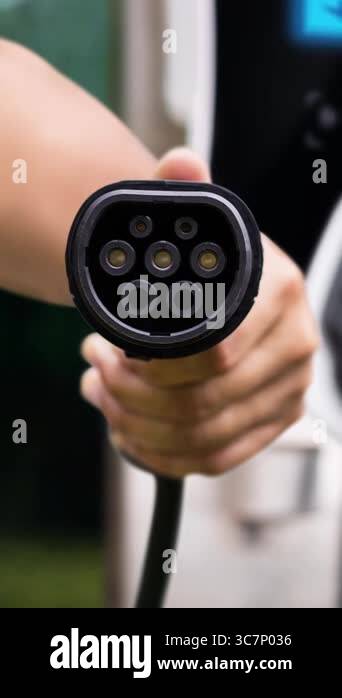 Focus EV charger pointing in front of camera display futuristic smart ...