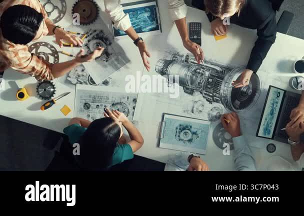 Top down aerial view of smart engineer team working together to design ...