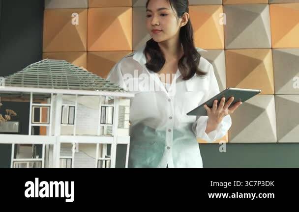 Beautiful project manager using tablet check house model. Portrait of architect engineer inspect ...