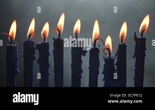 Shimmering flames dance atop nine candles in a hanukkah menorah ...