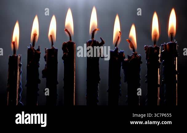 Shimmering flames dance atop nine candles in a hanukkah menorah ...