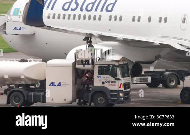 ALMATY, KAZAKHSTAN - MAY 12, 2024: Ground crew refueling commercial ...