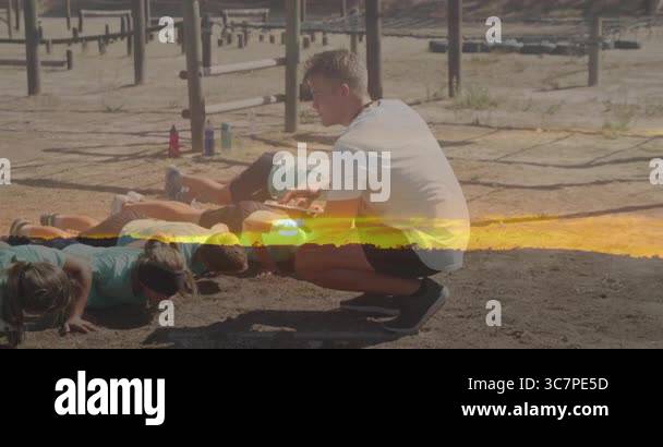 Children doing push-ups outdoors with coach over sunset landscape ...