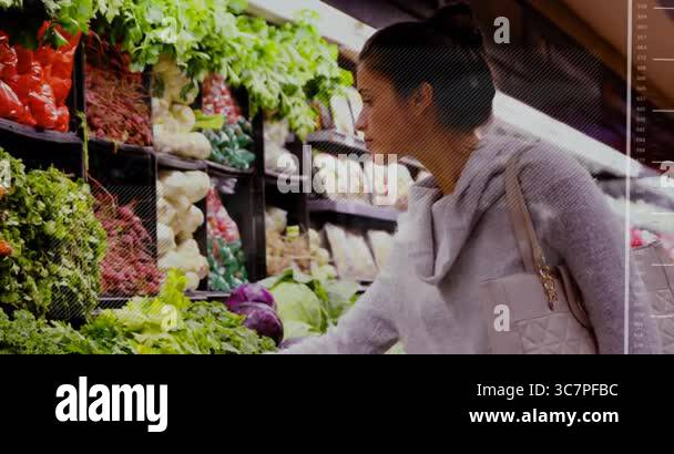 In grocery store, woman selecting fresh greens in produce section for ...