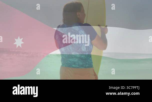 Holding surfboard with Jordanian flag design, person standing by ocean ...
