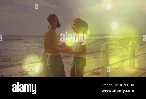 On beach, couple experiencing joyful moment with glowing light ...