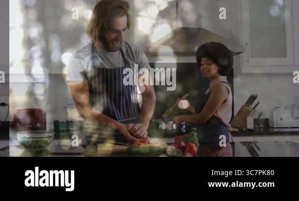 Cooking together in kitchen, couple using animation with bokeh light ...