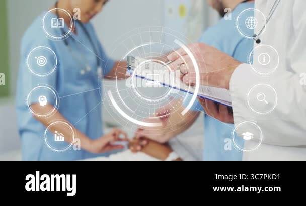 Reviewing data with digital interface, medical professionals analyzing ...