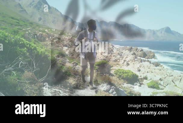 Hiking along rocky coastal path, man with animation of abstract shapes ...