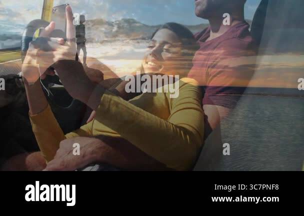Couple relaxing in car with sunset and beach overlay animation. travel ...