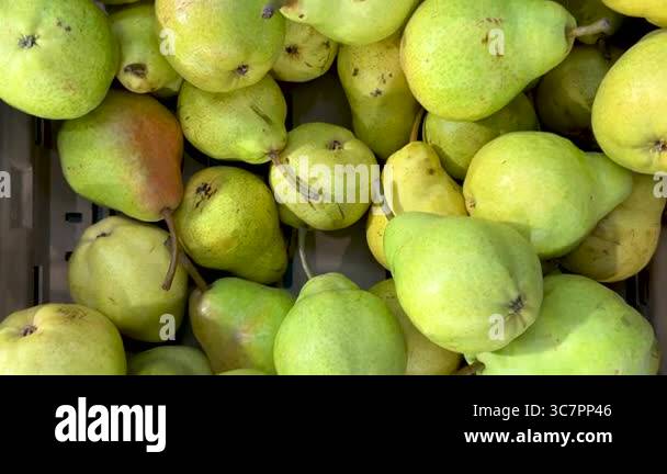 Williams pears in cardboard crate at the grocery store, tracking shot ...