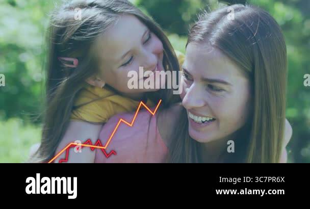 Smiling mother and daughter with animation of stock market graph lines ...