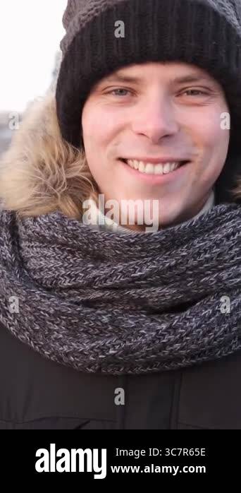 Portrait of a happy and relaxed man walking outdoors in a winter city ...